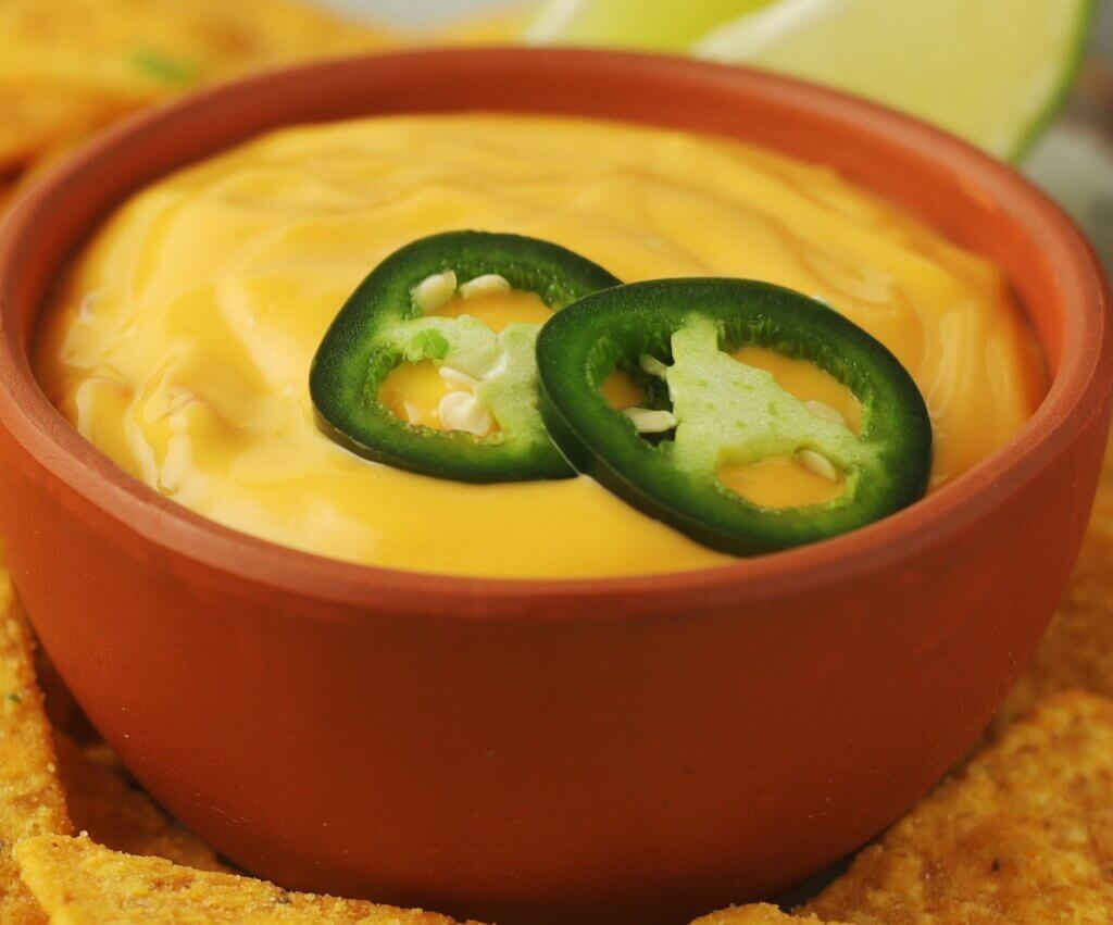 Introducing, Vaess plant-based cheese sauce with EDCO Jalapeño peppers ...